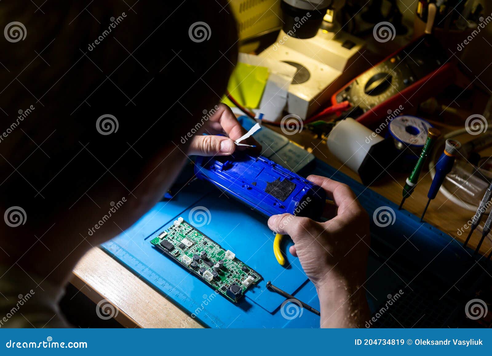 Electronics Repair Service, Workshop. the Master at the Table Repairs ...