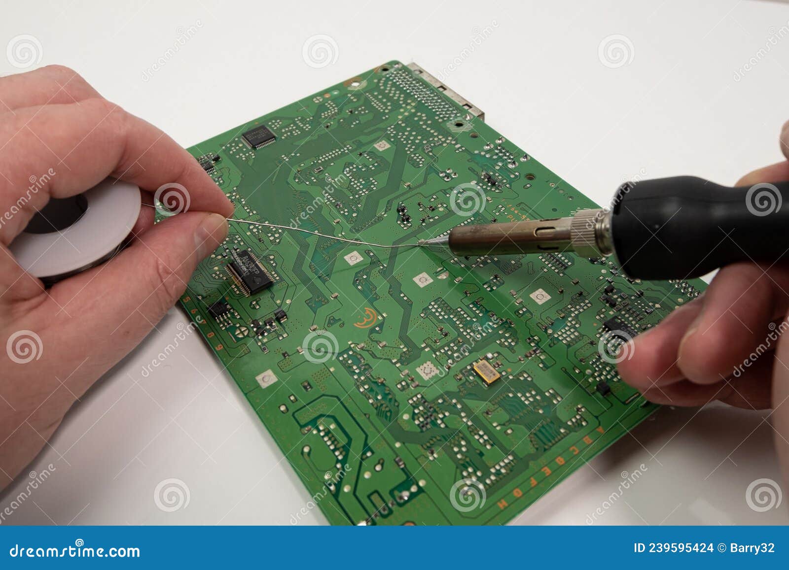 Electronics Repair. Technician Soldering Component on Circuit Board ...