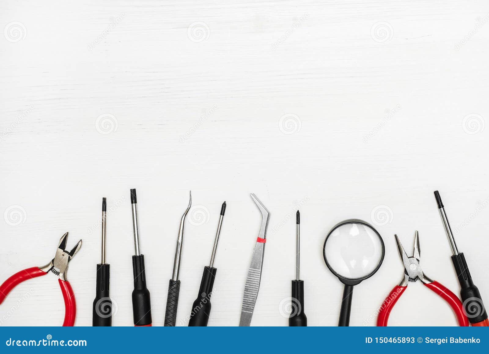 Electronics Repair Tools are Lined in a Row at the Bottom of the White ...