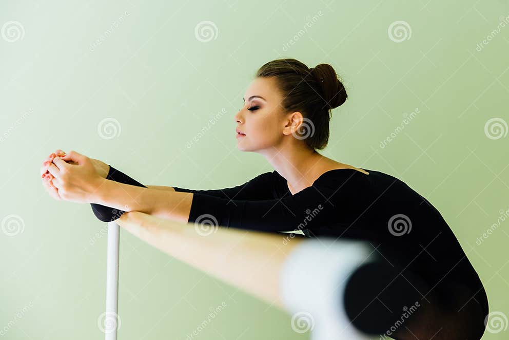 Elegant Beautiful Ballerina With A Perfect Body Doing Stretching