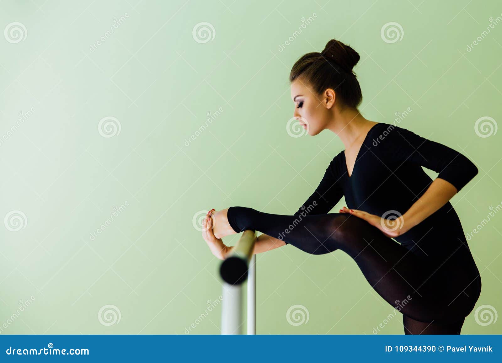 Elegant Beautiful Ballerina With A Perfect Body Doing Stretching