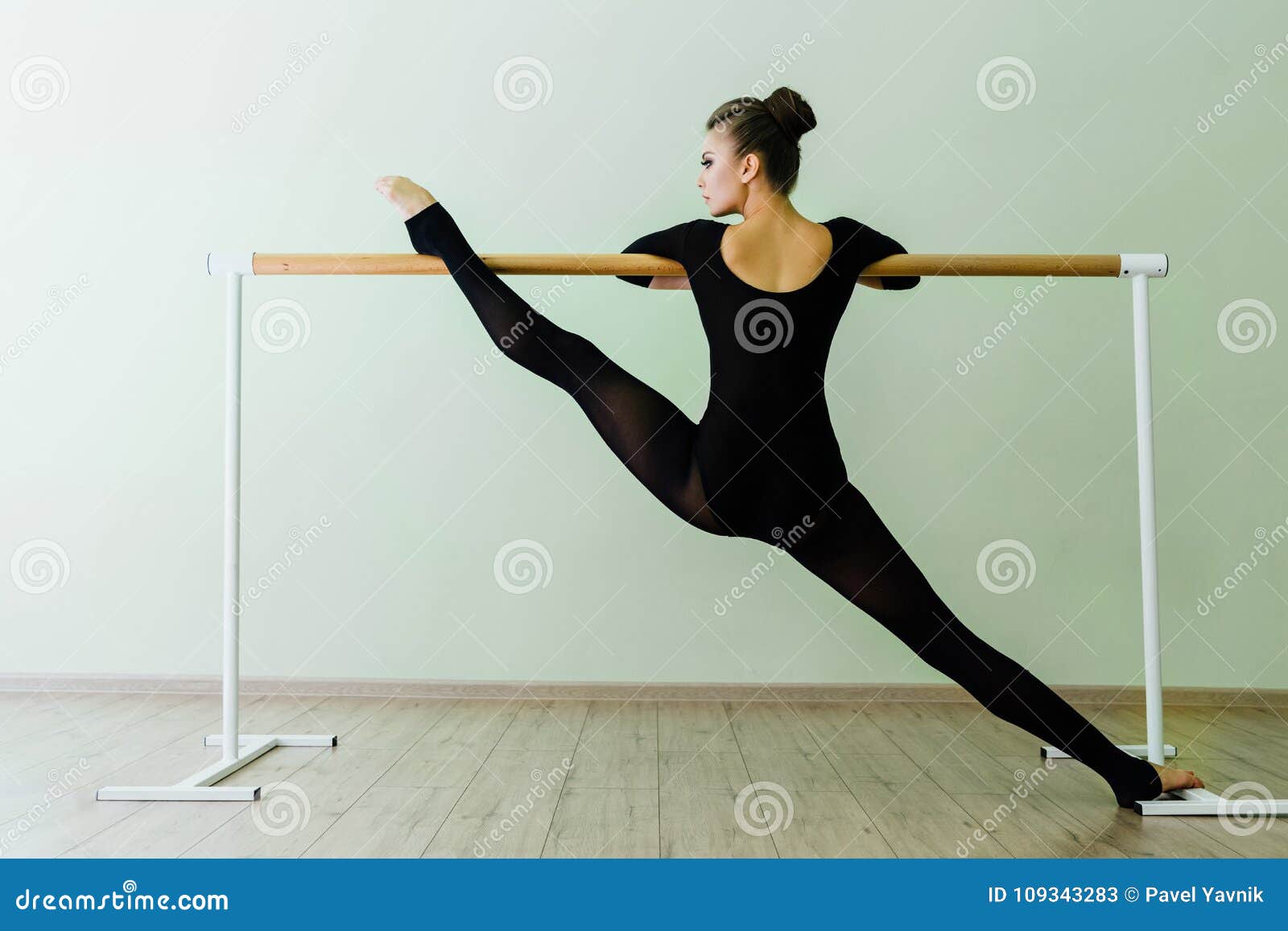 Elegant Beautiful Ballerina With A Perfect Body Doing Stretching