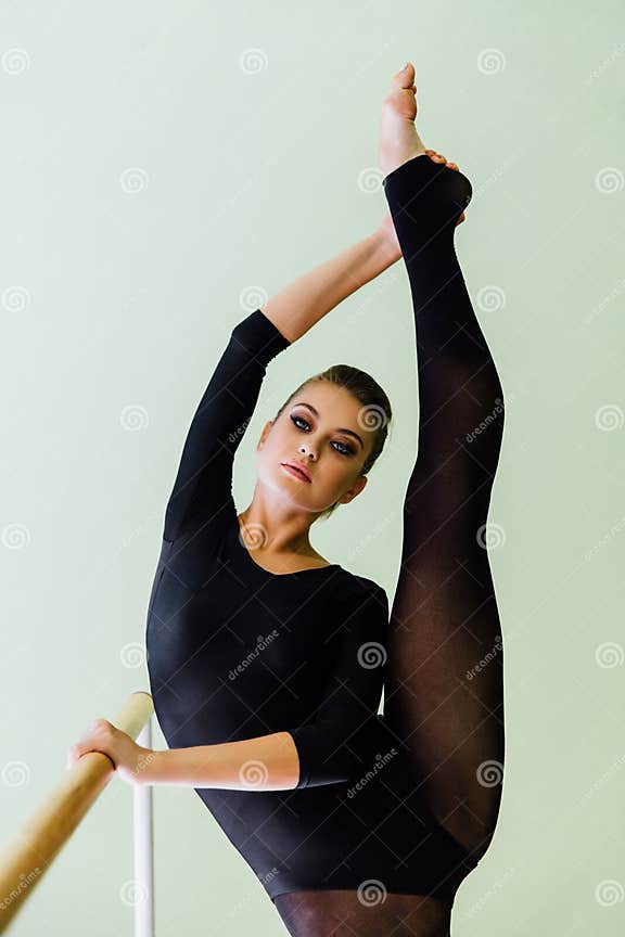 Elegant Beautiful Ballerina With A Perfect Body Doing Stretching