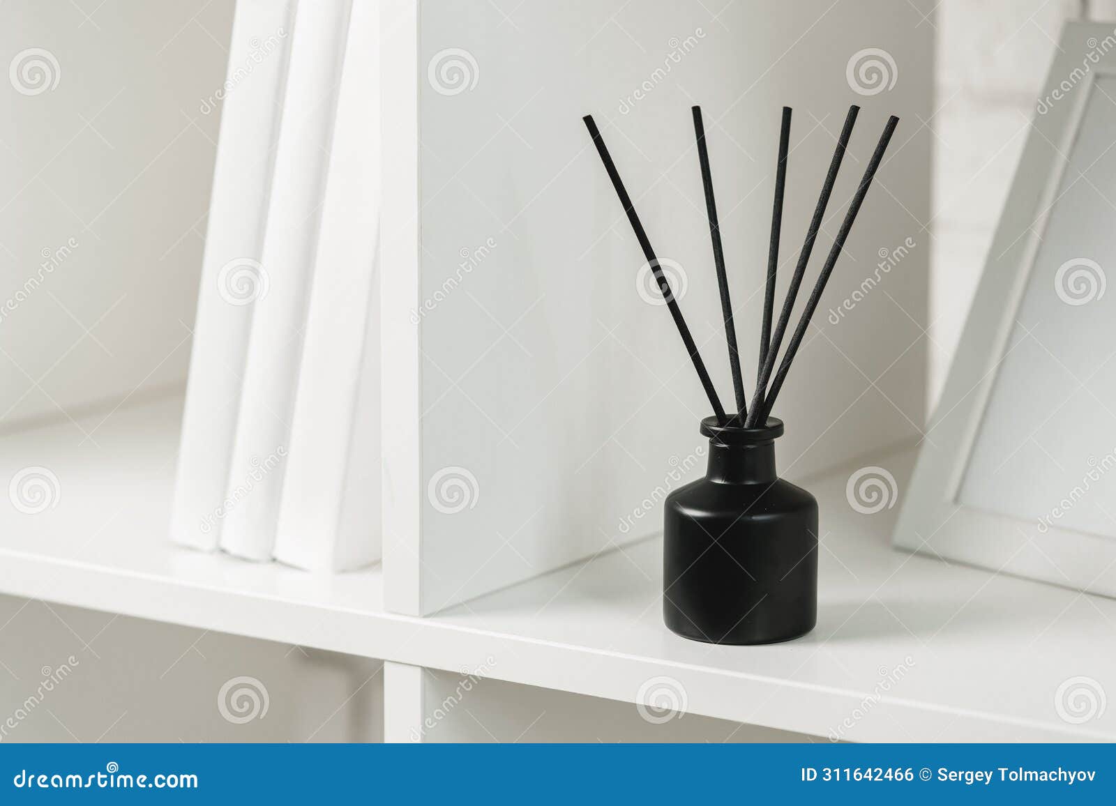 Elegant Black Reed Diffuser on White Shelf in Minimalist Home Decor ...