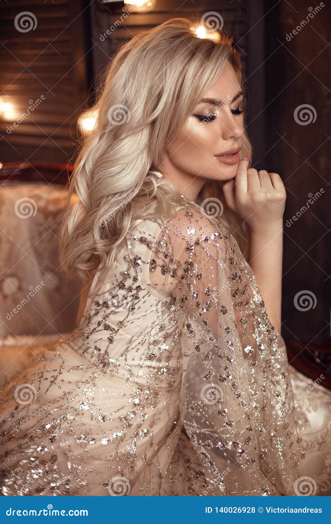 Elegant Blond Woman In Beige Dress Posing On Luxury Sofa In Royal