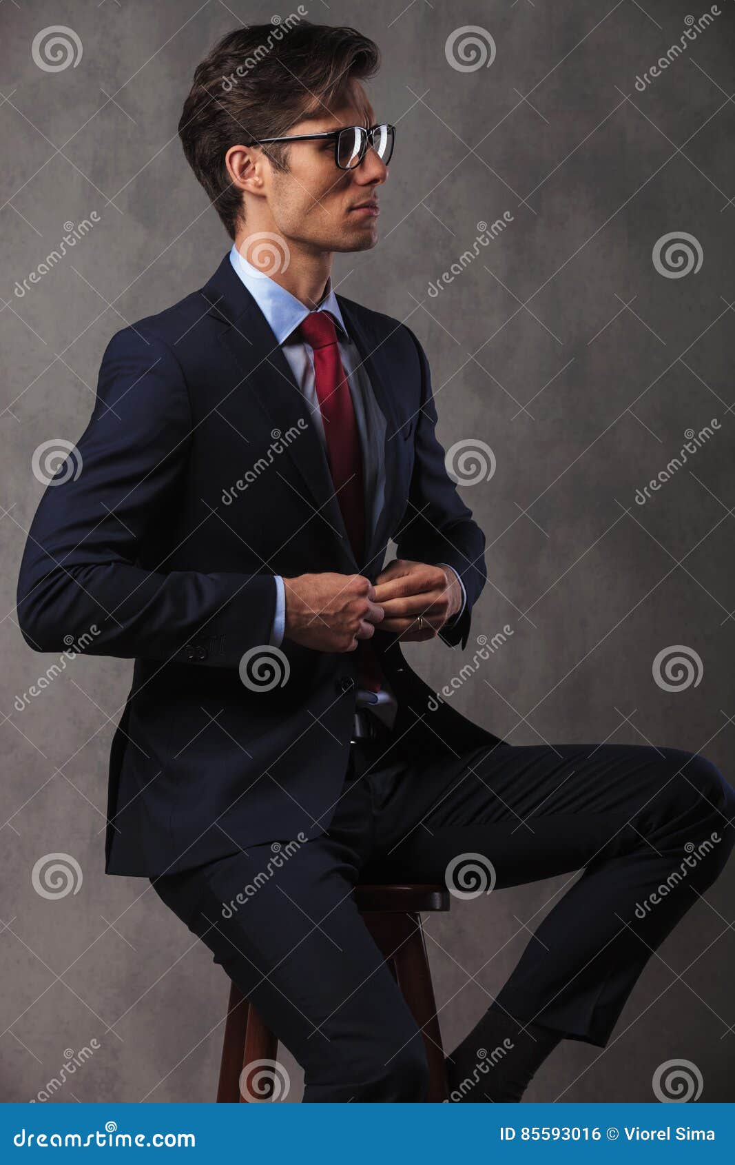 Elegant Business Man Buttoning His Suit while Sitting Stock Photo ...