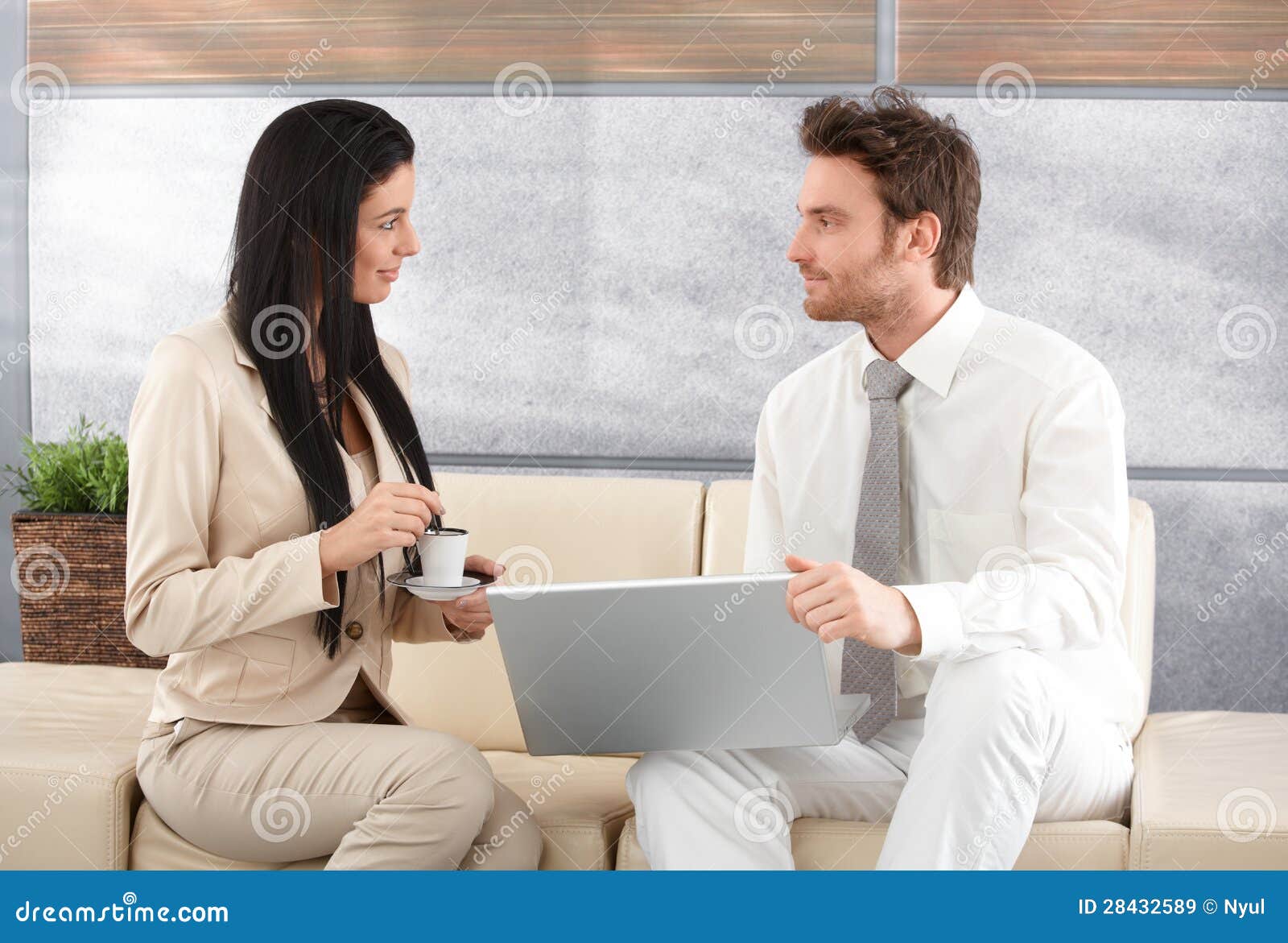Elegant Businesspeople Using Laptop Talking Stock Image - Image of ...
