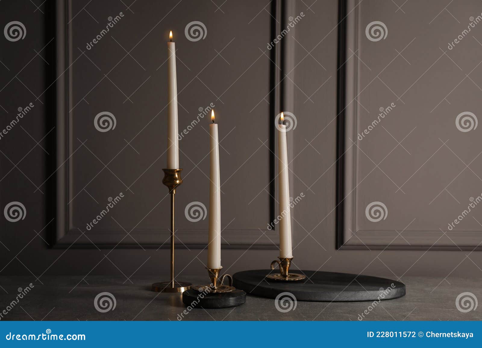 Elegant Candlesticks with Burning Candles on Grey Stock Photo - Image ...