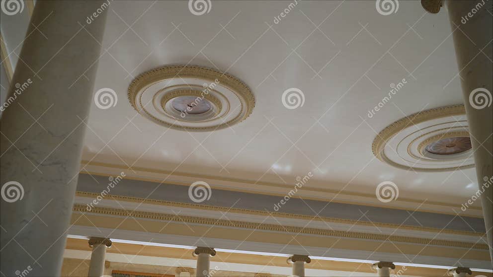 Elegant Ceiling Design with Circular Patterns and Marble Columns in ...