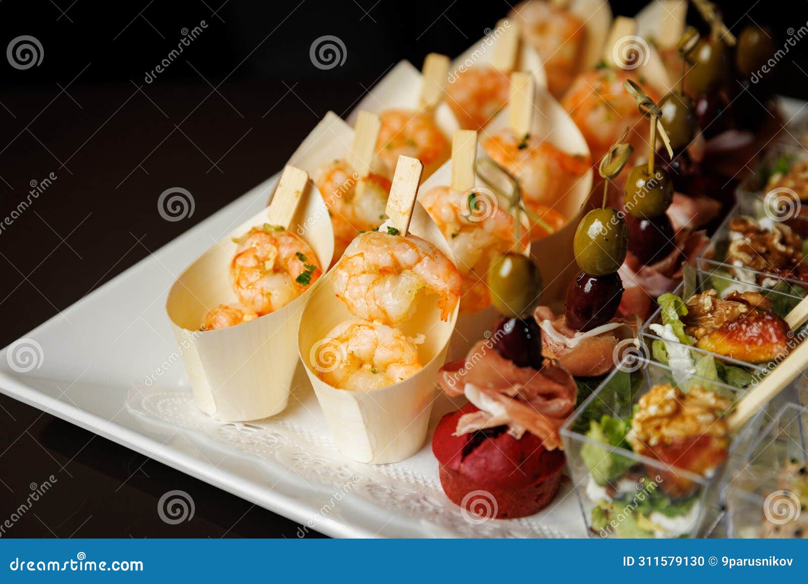 An Elegant Display of Various Appetizers on a White Platter Stock Photo ...