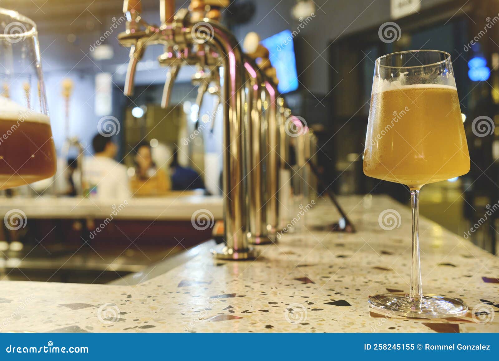 Elegant Glass of Craft Beer and Taps. Beer Taps in a Row in Perspective ...