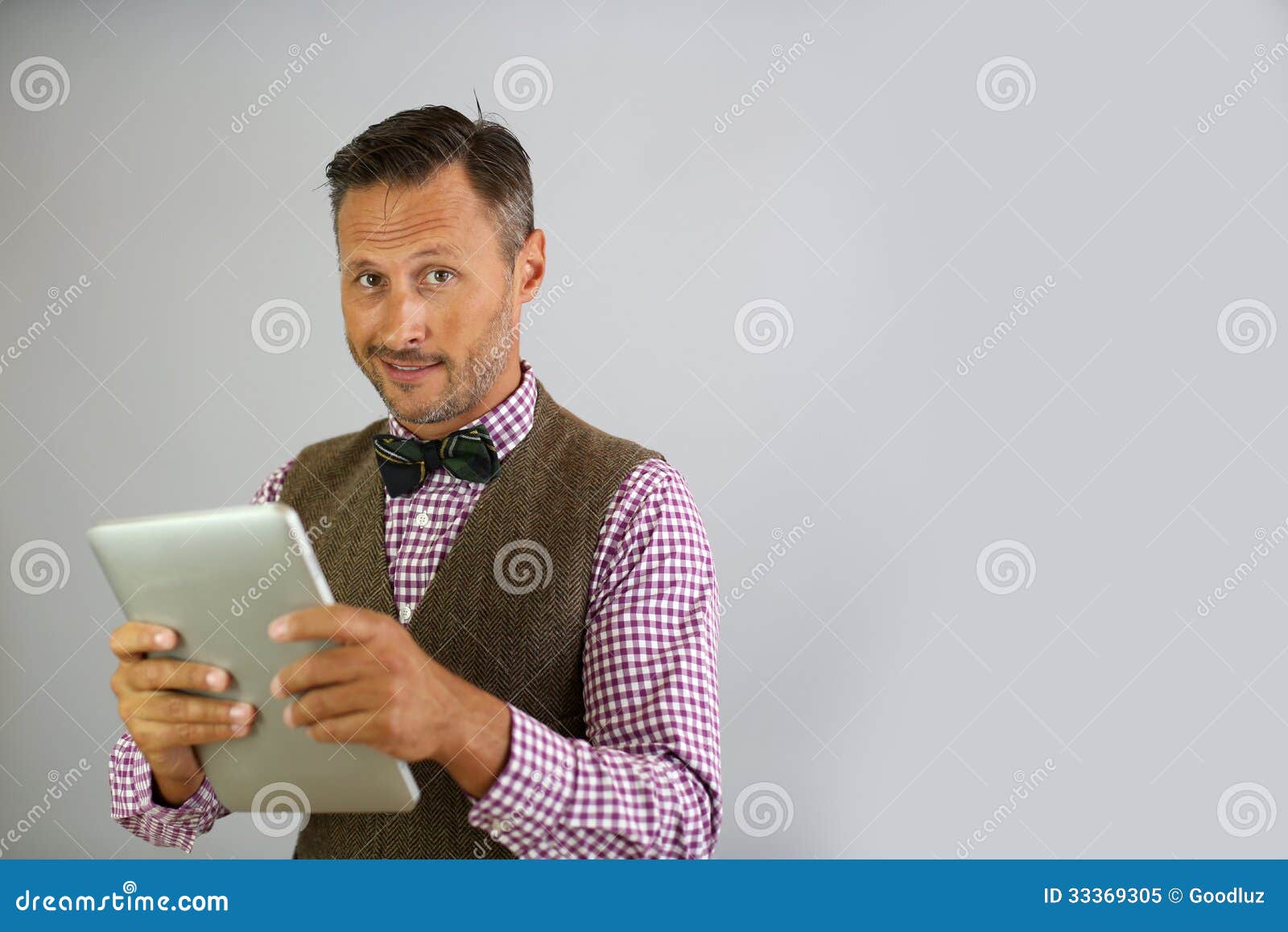 Elegant guy using tablet stock image. Image of mature - 33369305