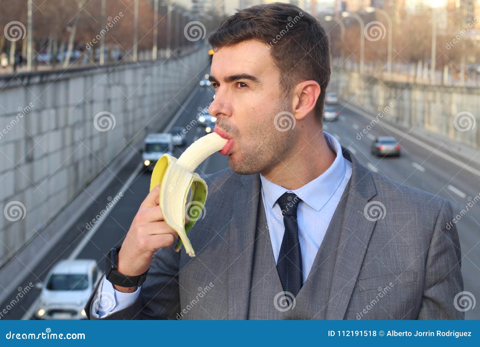 Elegant Man Biting a Banana Stock Photo - Image of erotic, blow: 112191518