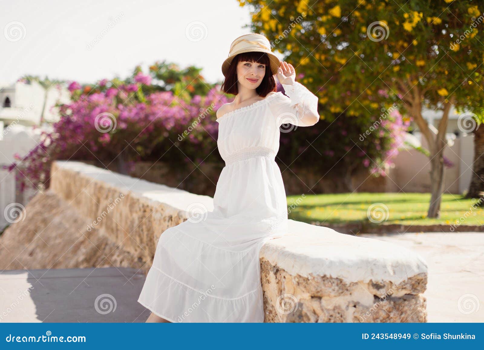 Elegant Pretty Slim Woman With Straw Hat And Long Beach White Dress