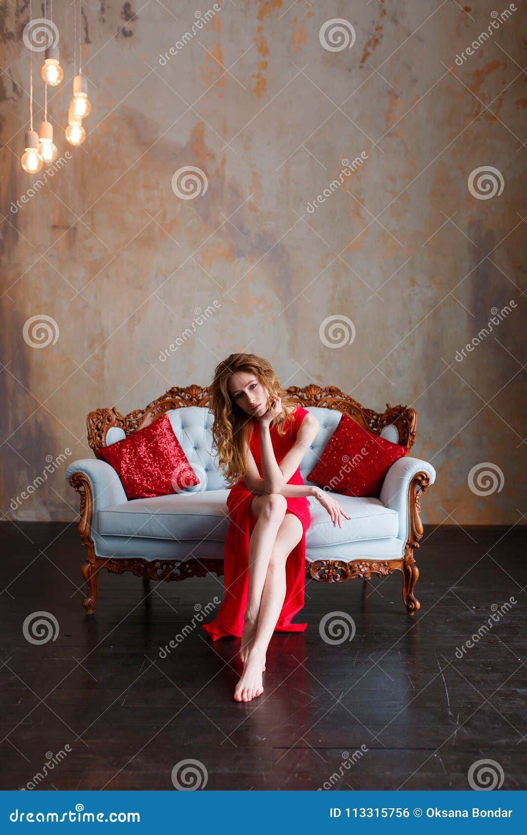 Elegant Sensual Young Redhair Woman In Red Dress Sitting On Classic