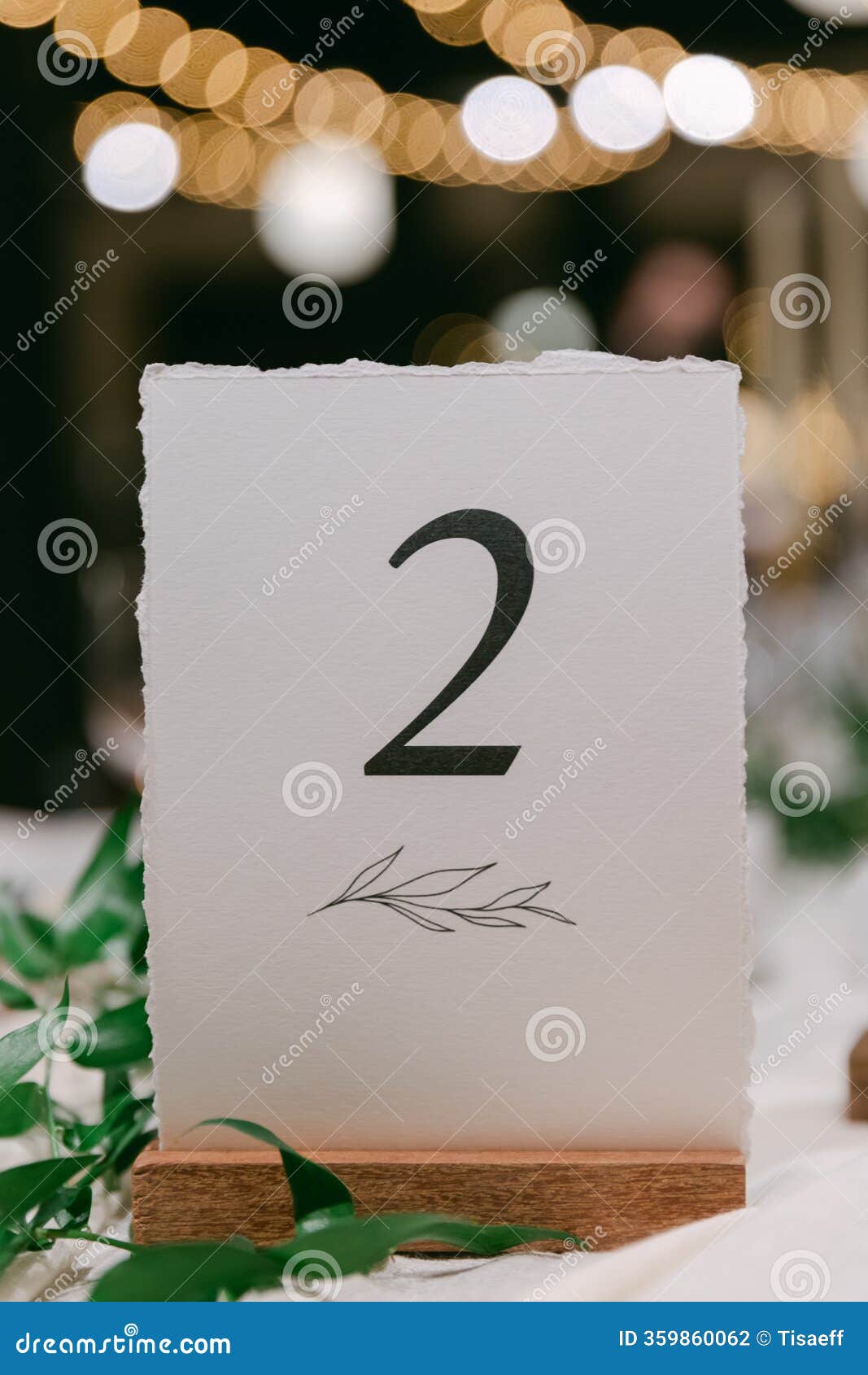 Elegant Table Number Two Stands Ready at an Event with Soft Lighting ...