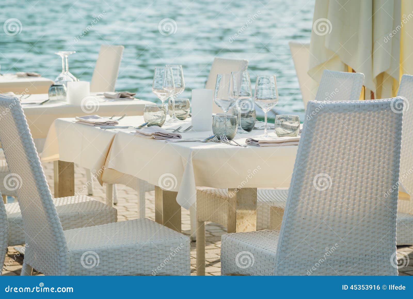 Elegant Table Set on the Sea Stock Photo - Image of chairs, water: 45353916