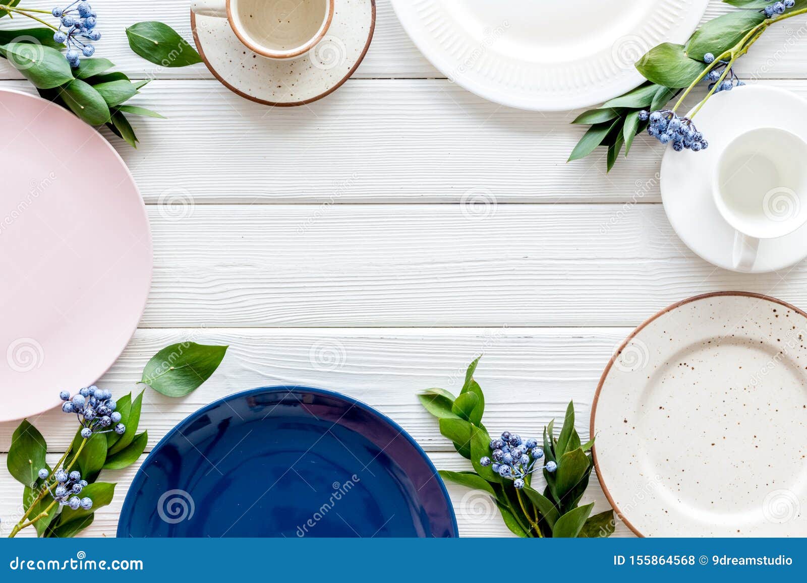 Elegant Table Setting with Plates and Flowers Frame on White Wooden ...