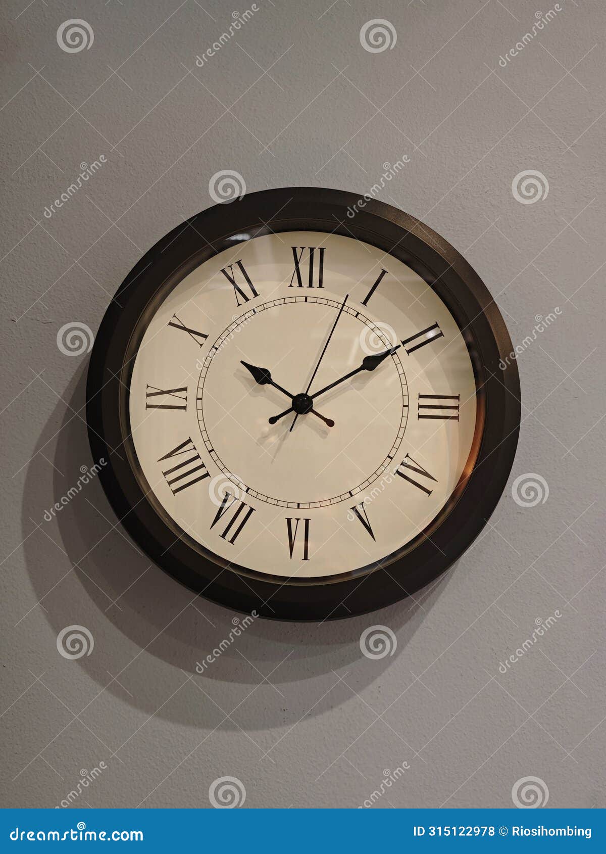 Elegant Wall Clock with Roman Numerals on Subtle Grey Background Stock ...
