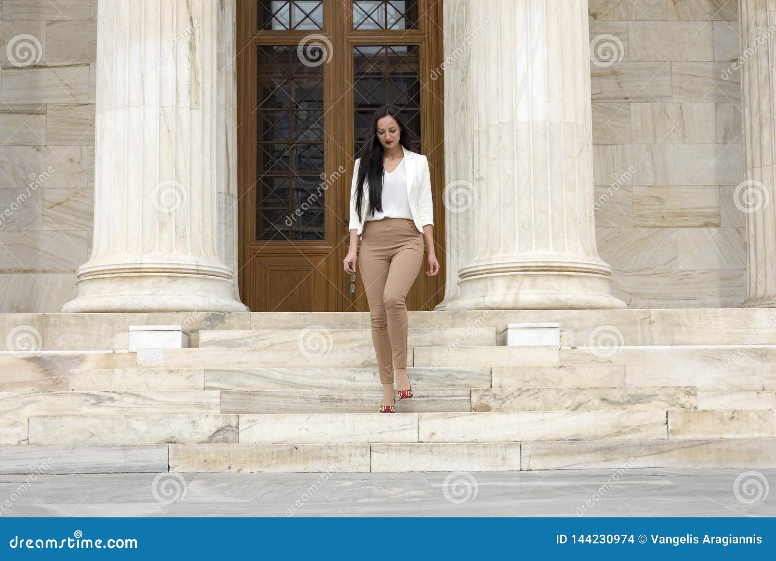 Elegant Woman while Exiting Building Stock Photo - Image of house ...