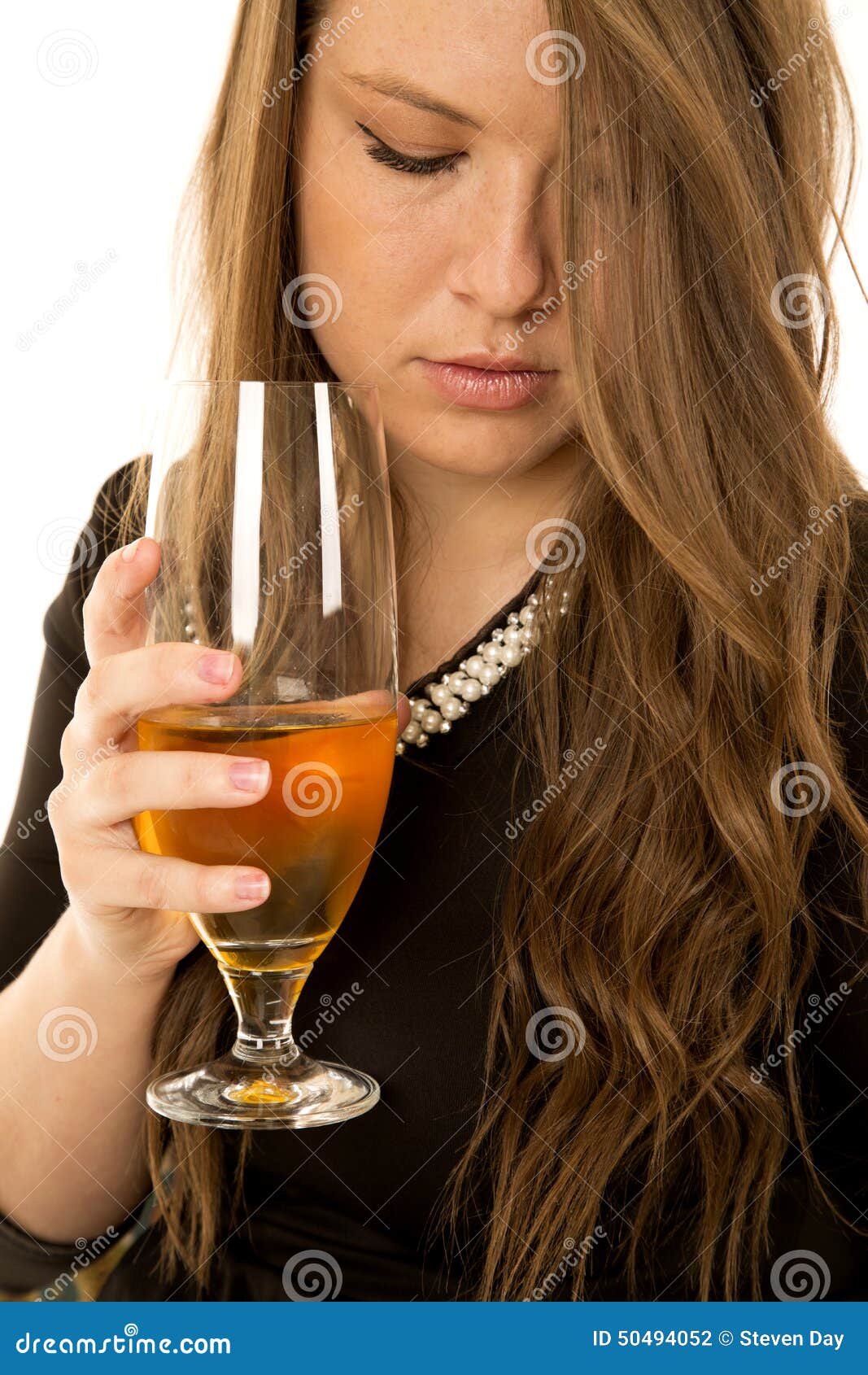 Elegant Young Female Model Holding Drink Looking Down Stock Photo ...