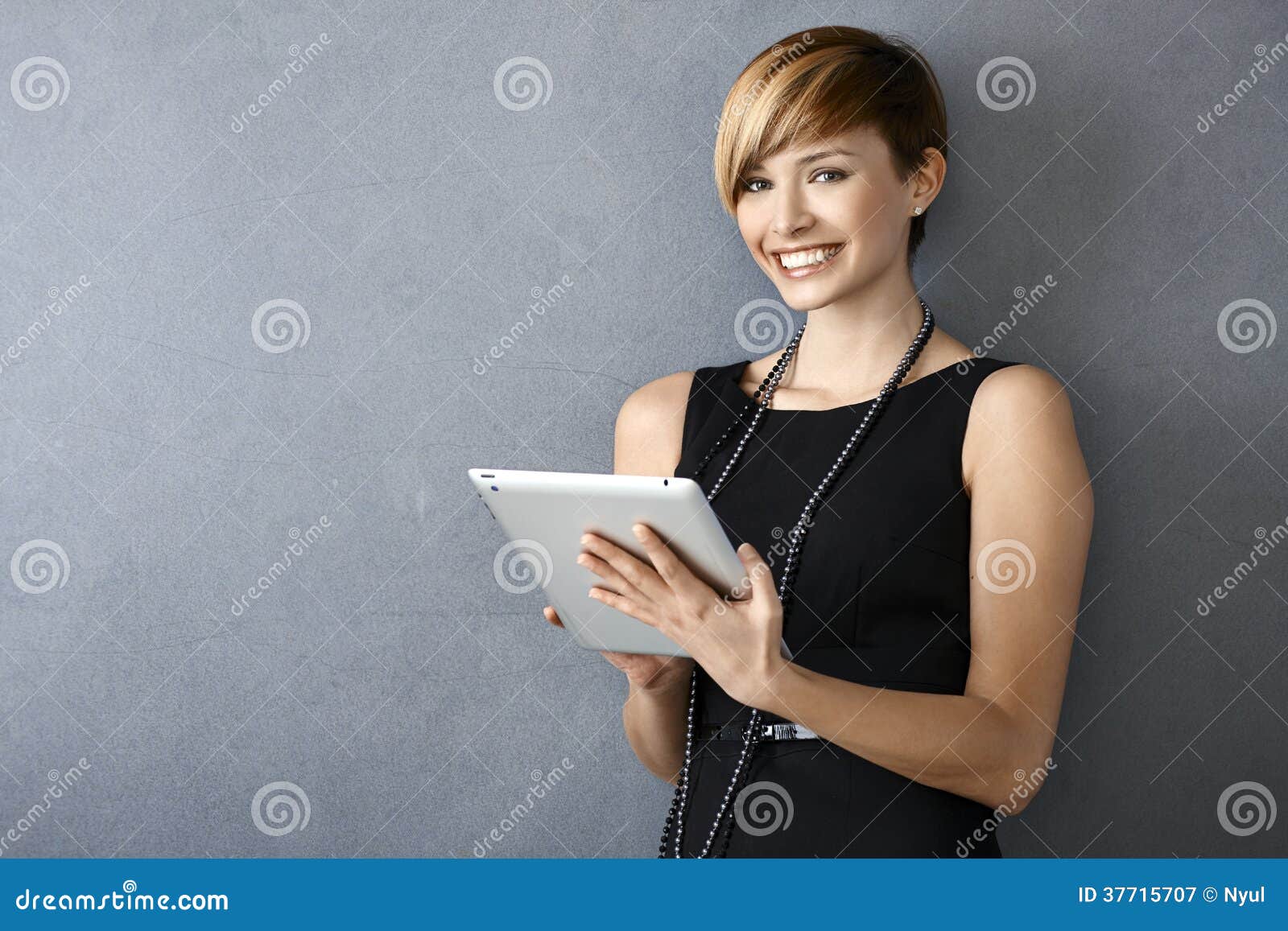 Elegant Young Woman Using Tablet Leaning To Wall Stock Image - Image of ...