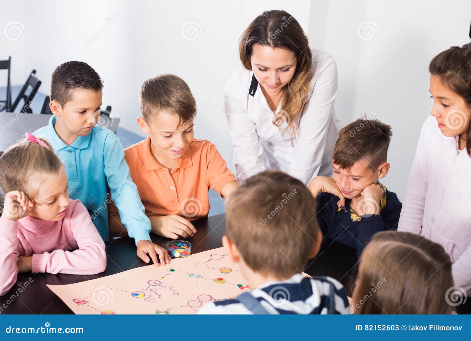 Elementary Age Interested Children at Table with Board Game and Stock ...