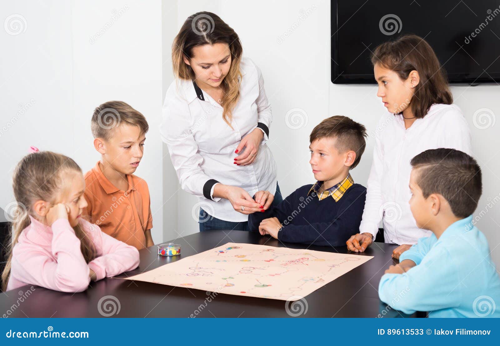Elementary Age Kids at Table with Board Game and Dice Stock Image ...