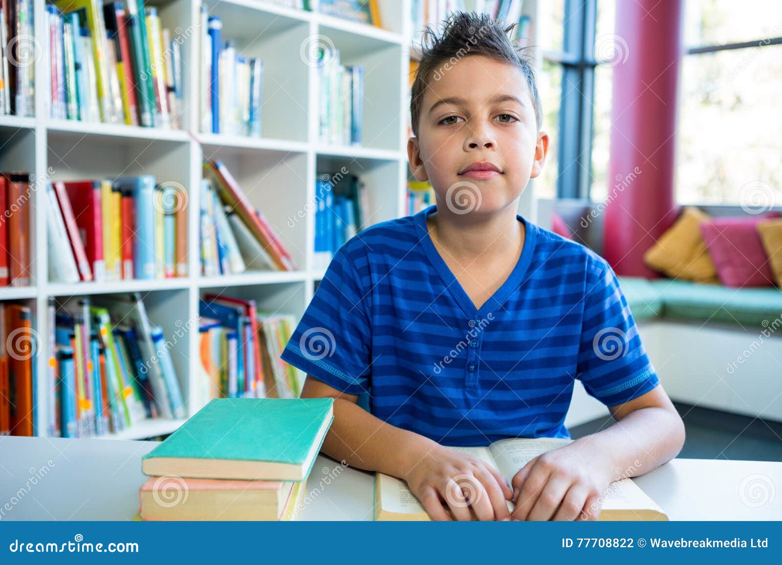 Elementary Boy Reading Book in School Library Stock Photo - Image of ...