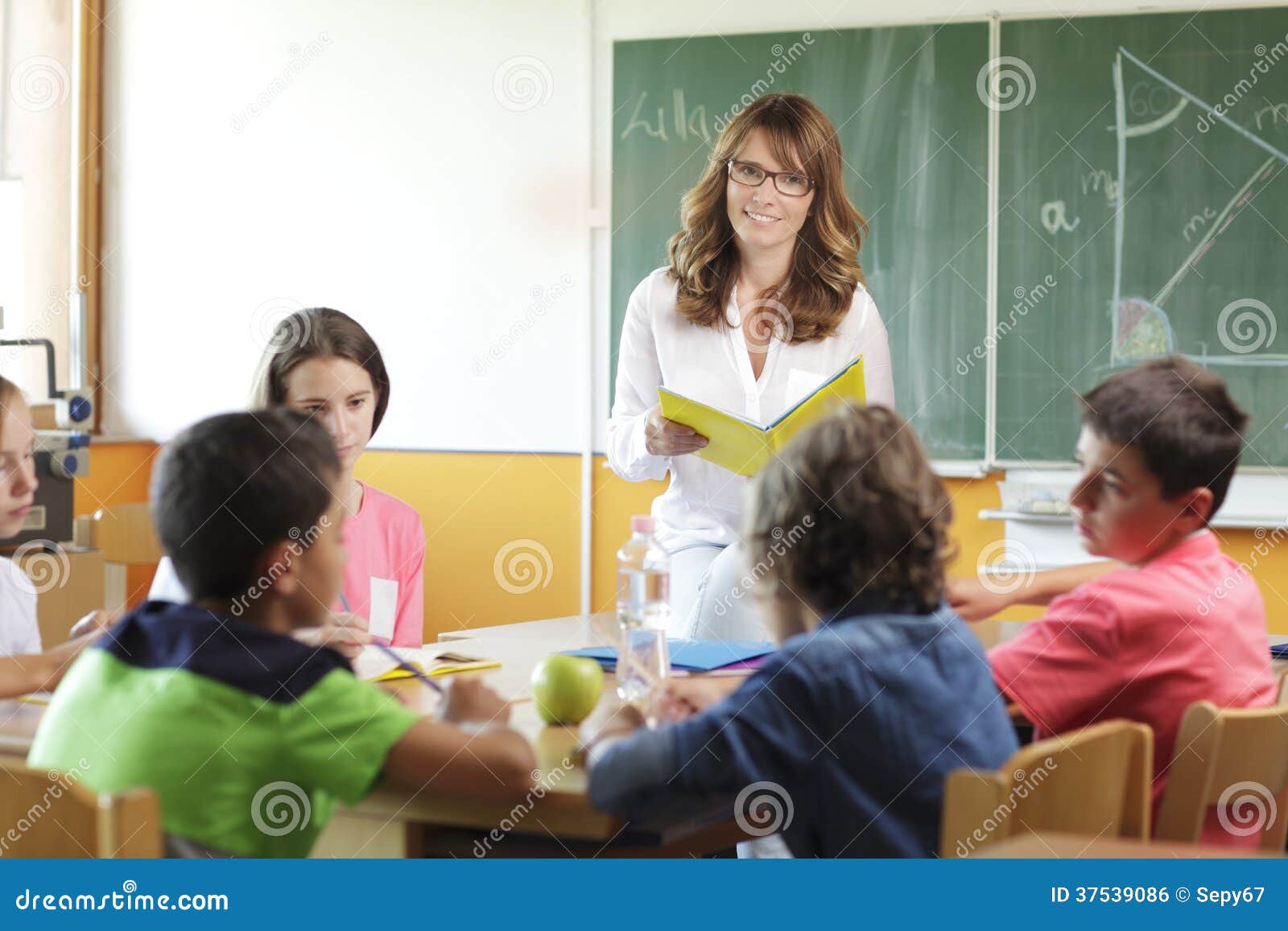 Elementary Classroom Setting. Focus on Teacher and Chalkboard. Stock ...