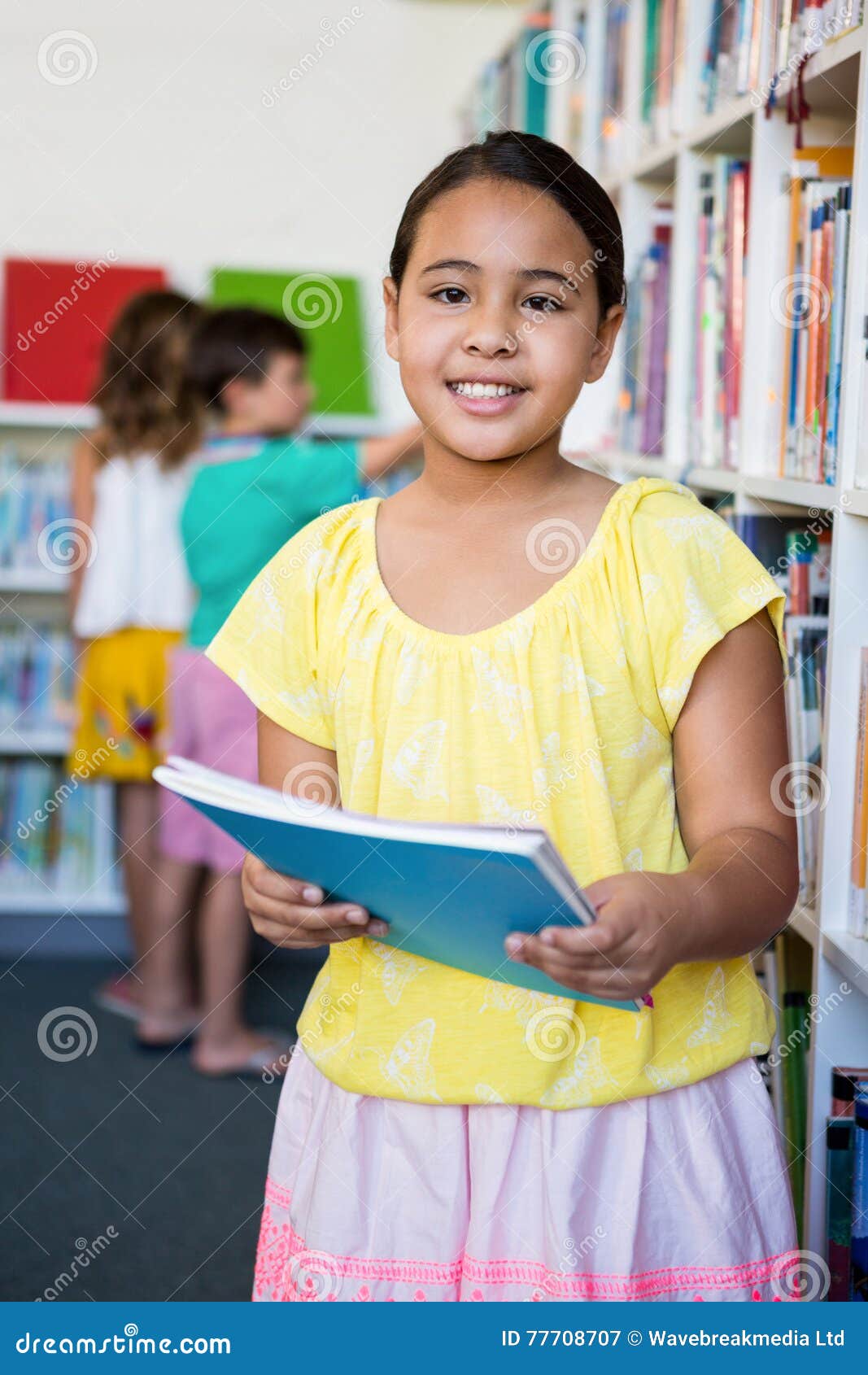 Elementary Girl Holding Books in School Library Stock Image - Image of ...