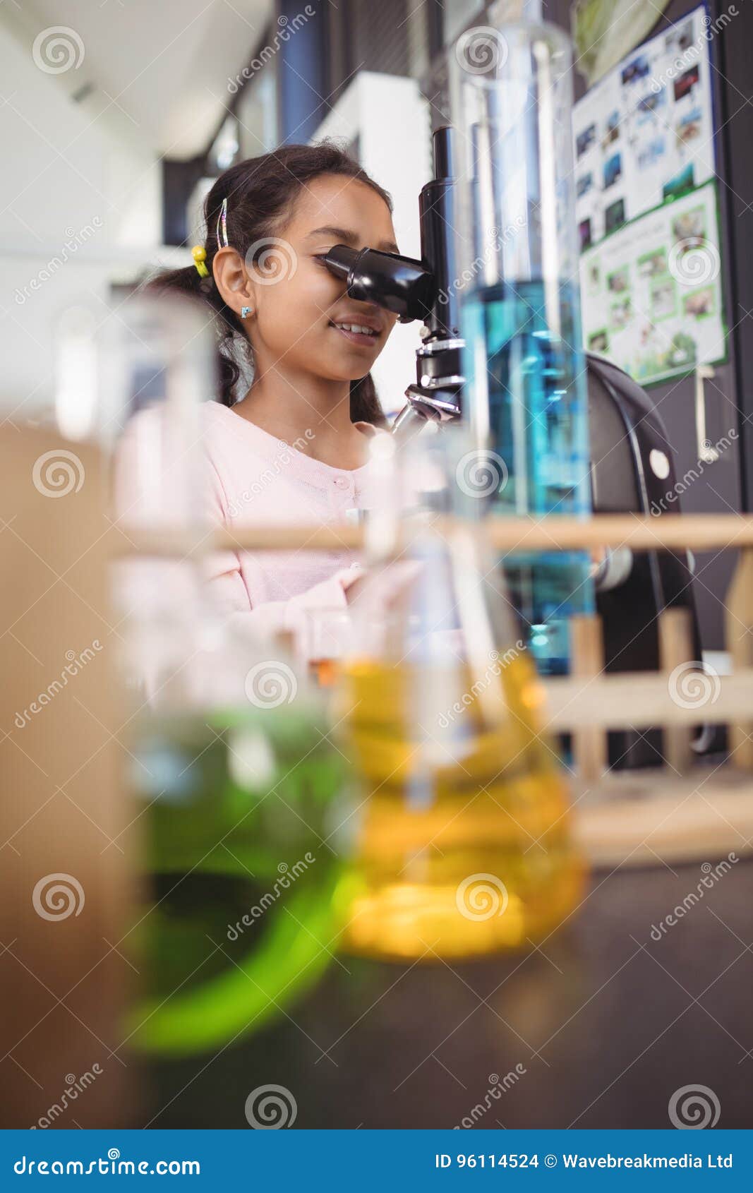 Elementary Girl Student Using Microscope at Laboratory Stock Photo ...