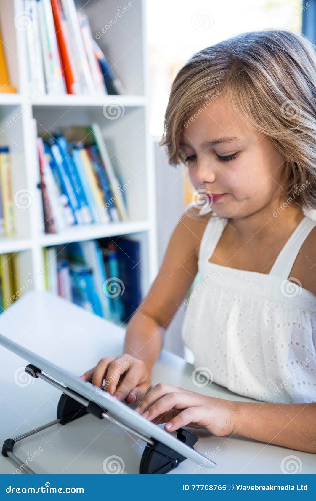 Elementary Girl Using Digital Tablet in Library Stock Image - Image of ...
