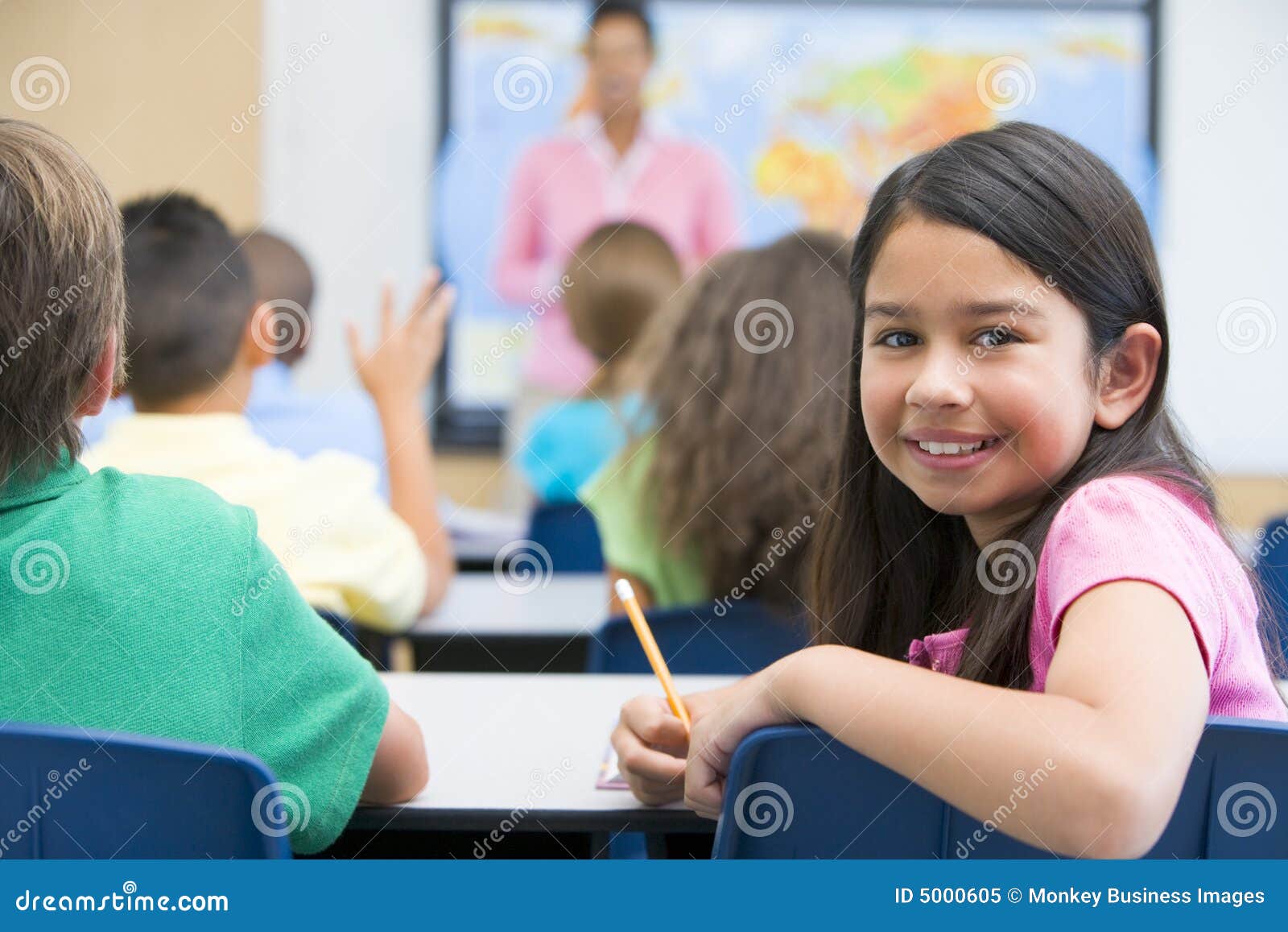 Elementary Pupil Showing Drawing To Classmates In Classroom Royalty ...