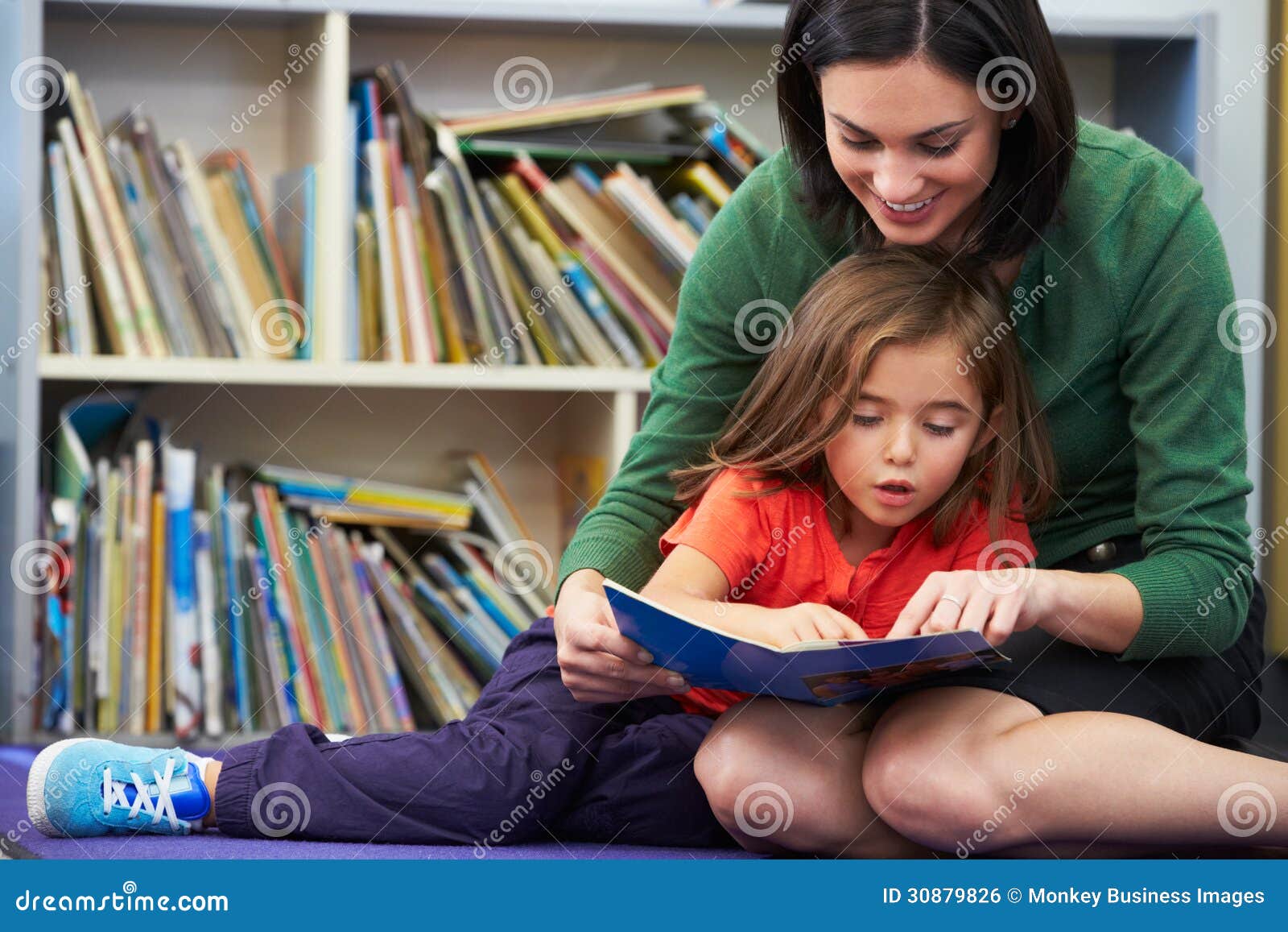 Elementary Pupil Reading with Teacher in Classroom Stock Photo - Image ...