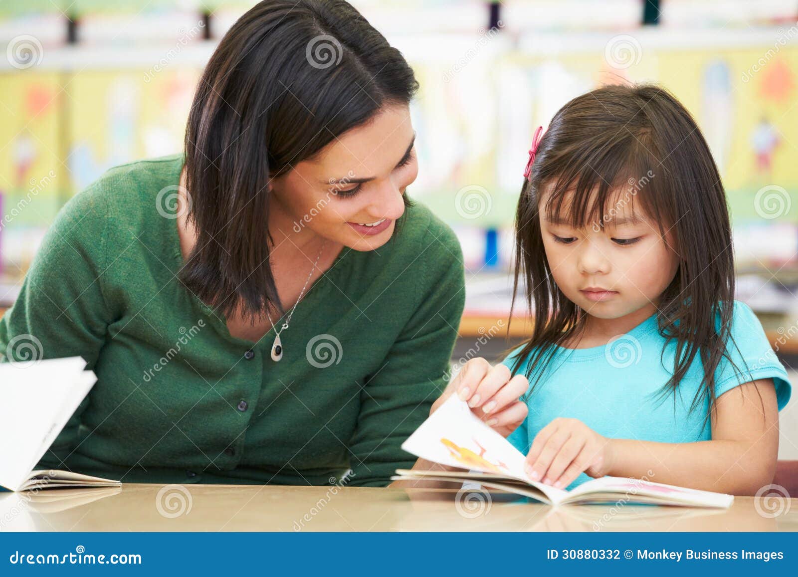Elementary Pupil Reading with Teacher in Classroom Stock Photo - Image ...