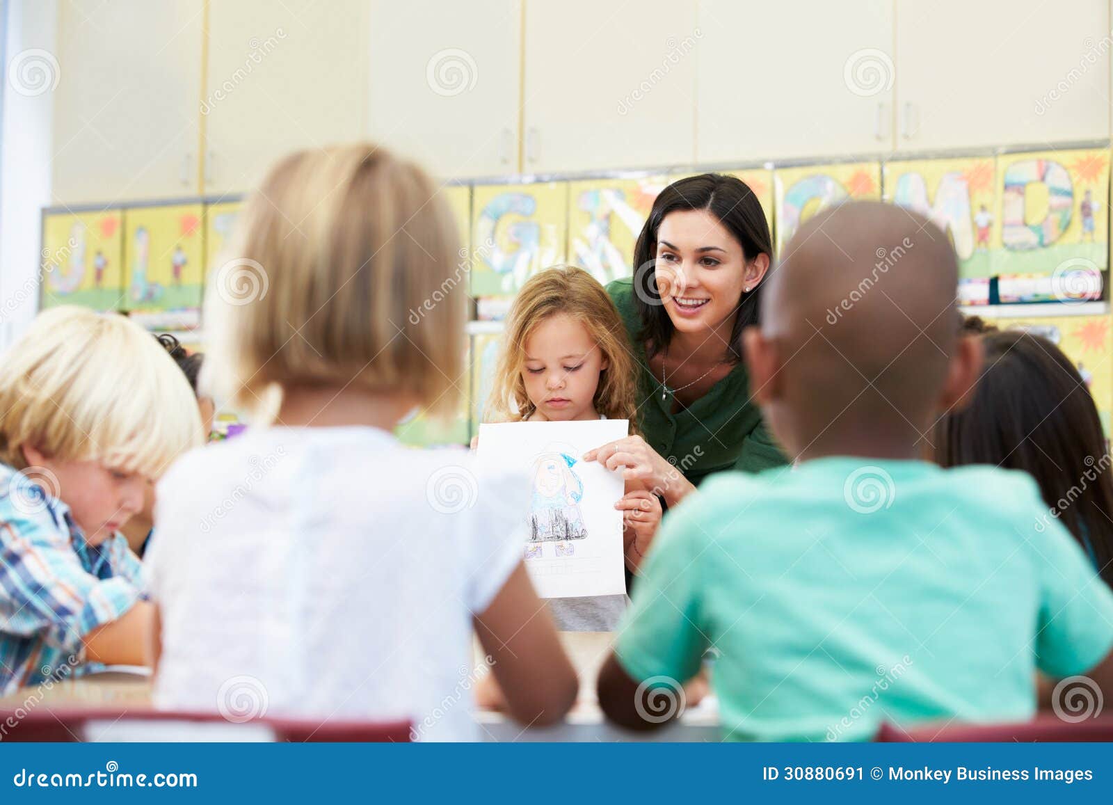 Elementary Pupil Showing Drawing To Classmates in Classroom Stock Image ...