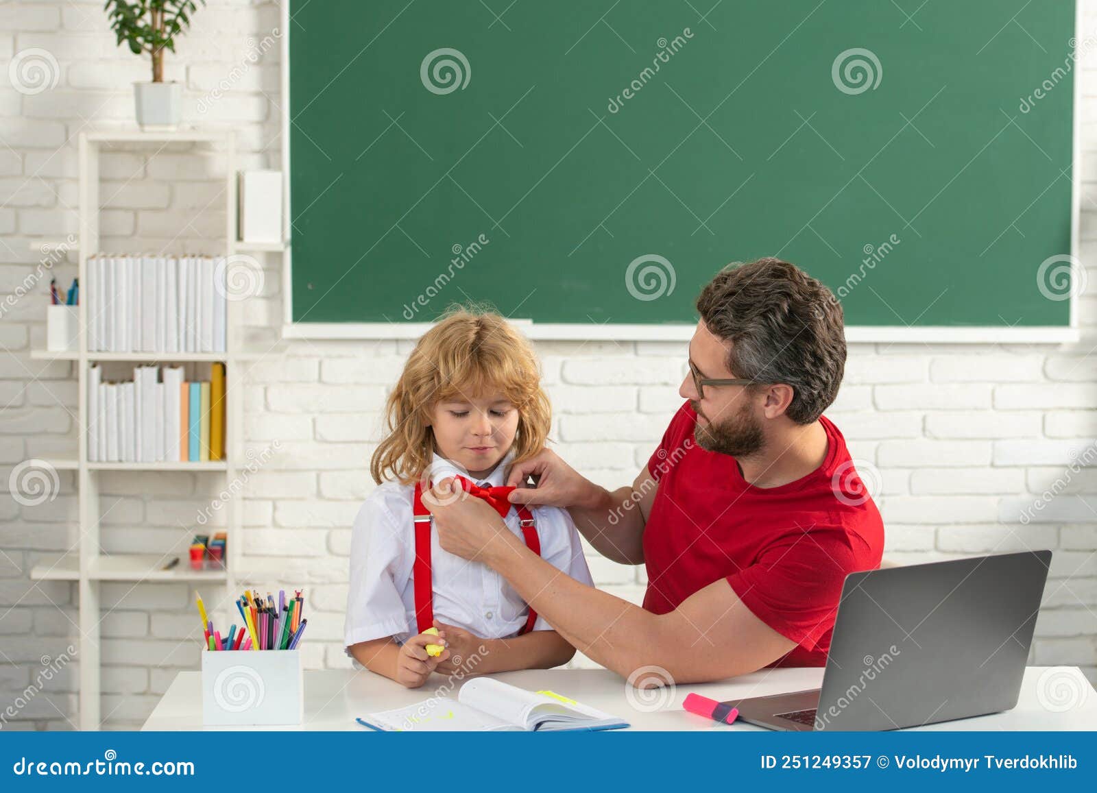 Elementary School Boy in Classroom on Lesson. Teacher Explaining To ...