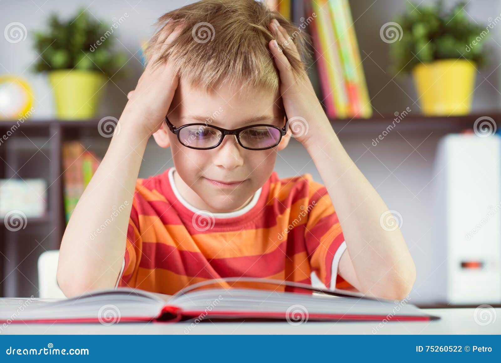 Elementary School Boy at Desk Reading Boock Stock Photo - Image of ...