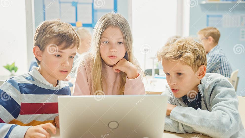 Elementary School Classroom: Diverse Group of Brilliant Children Using ...