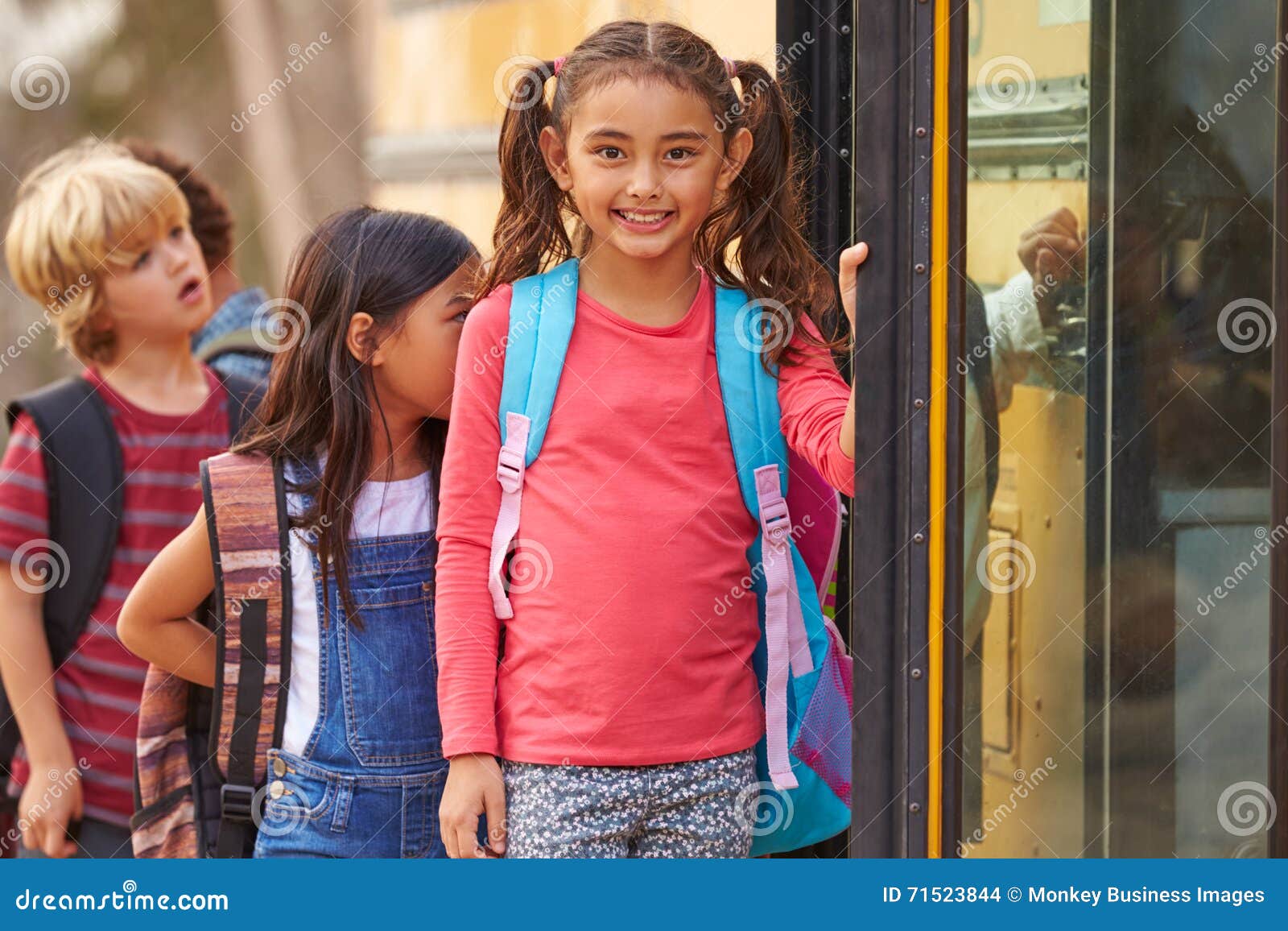 Elementary School Girl at the Front of the School Bus Queue Stock Photo ...