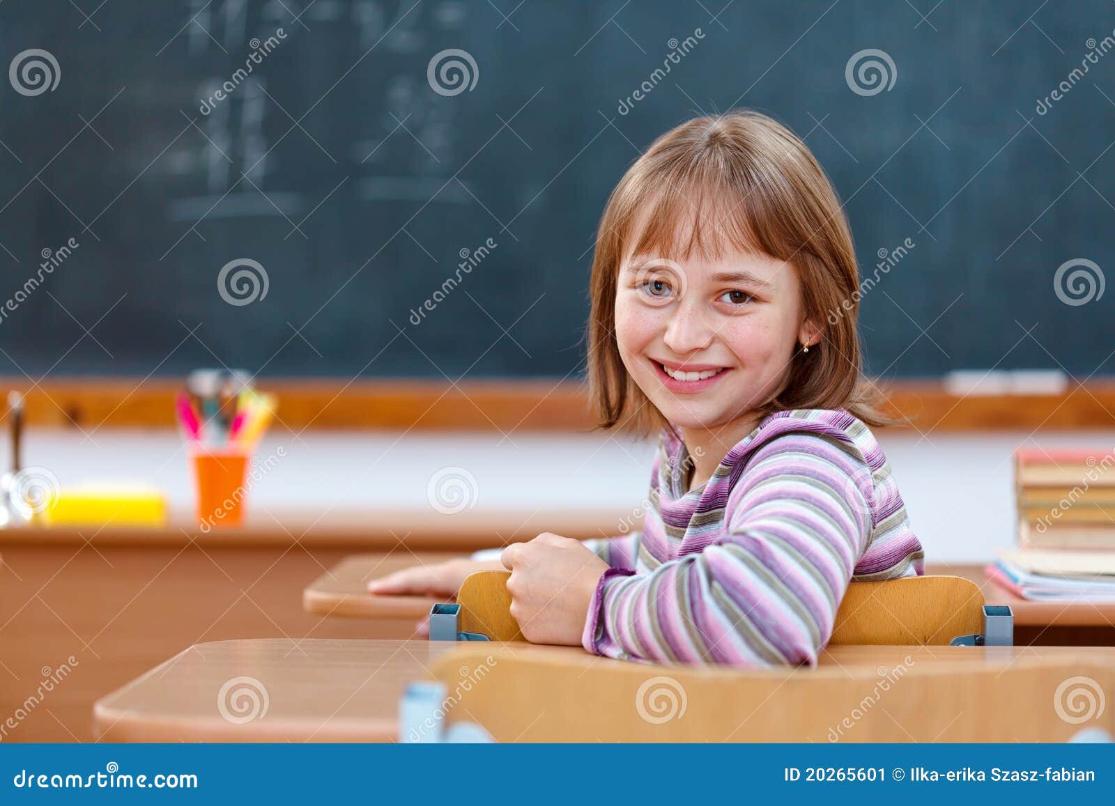 Elementary School Girl Turning Back and Smiling Stock Image - Image of ...