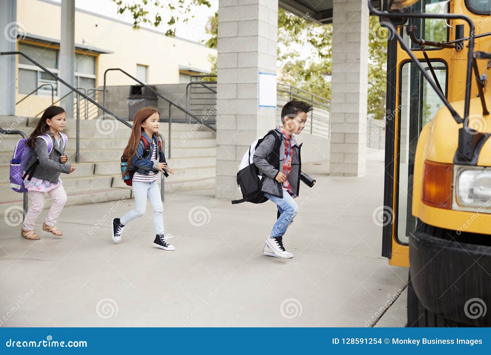 Elementary School Kids Leaving School To Get the School Bus Stock Photo ...