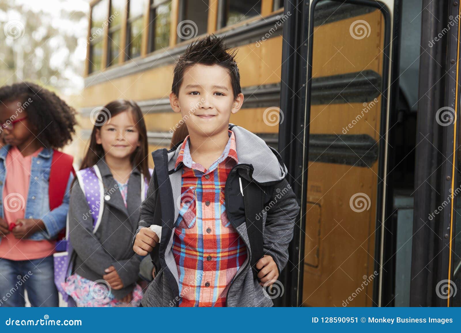 Elementary School Kids Queueing for the School Bus Stock Image - Image ...