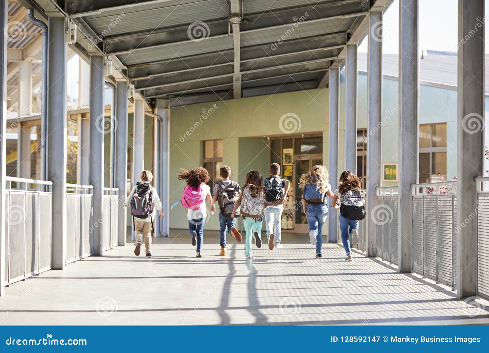 Elementary School Kids Running in School Corridor, Back View Stock ...