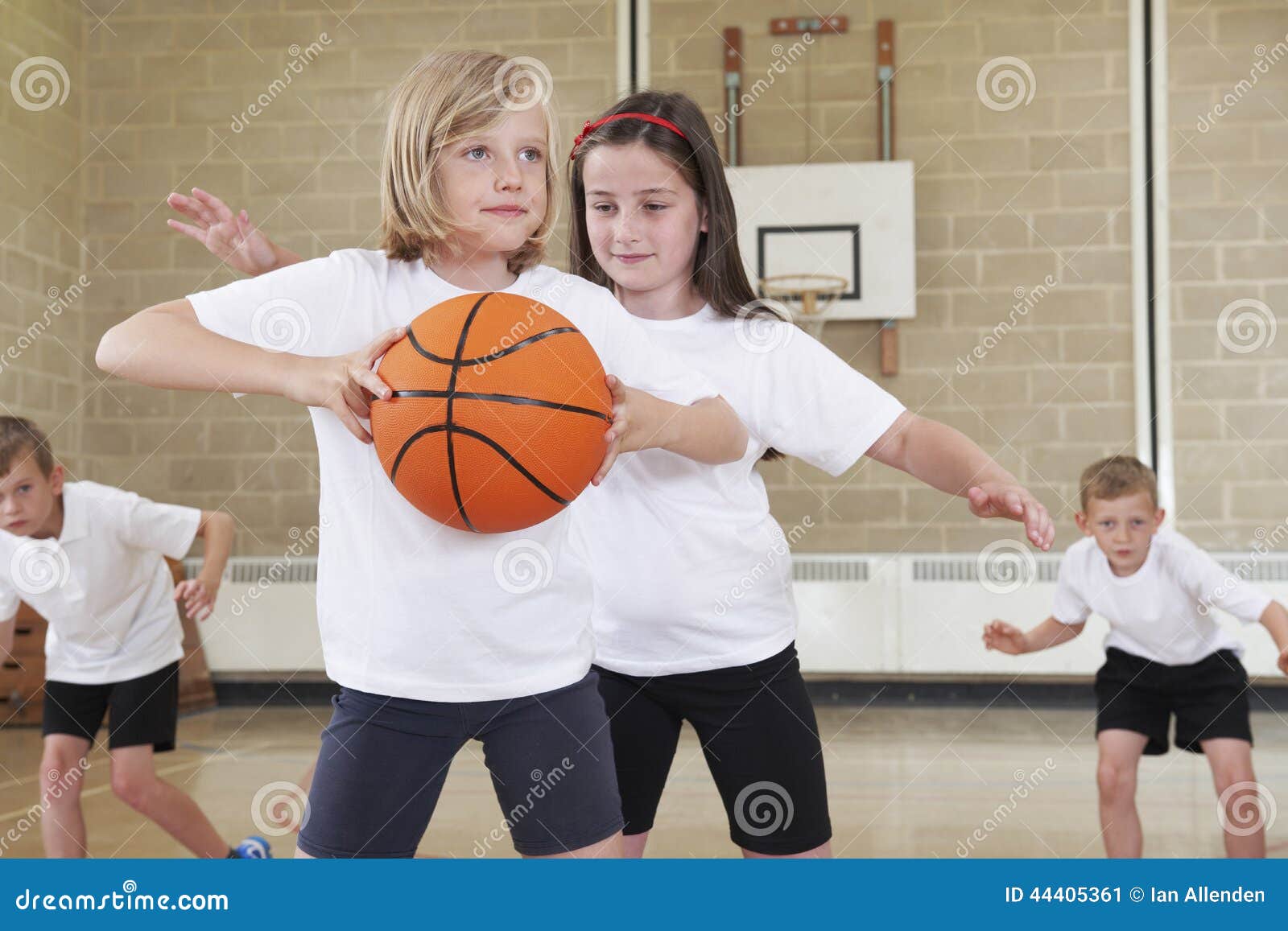 Elementary School Pupils Playing Basketball In Gym Royalty-Free Stock ...