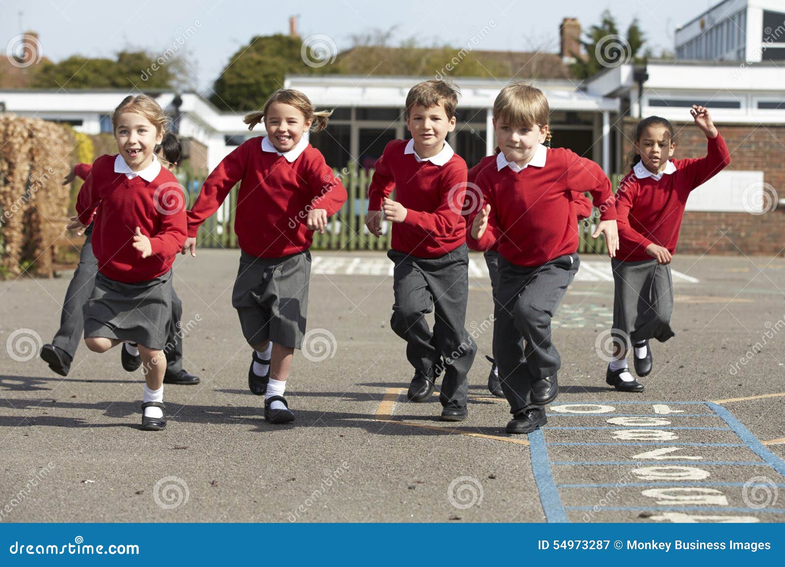 Elementary School Pupils Running in Playground Stock Image - Image of ...