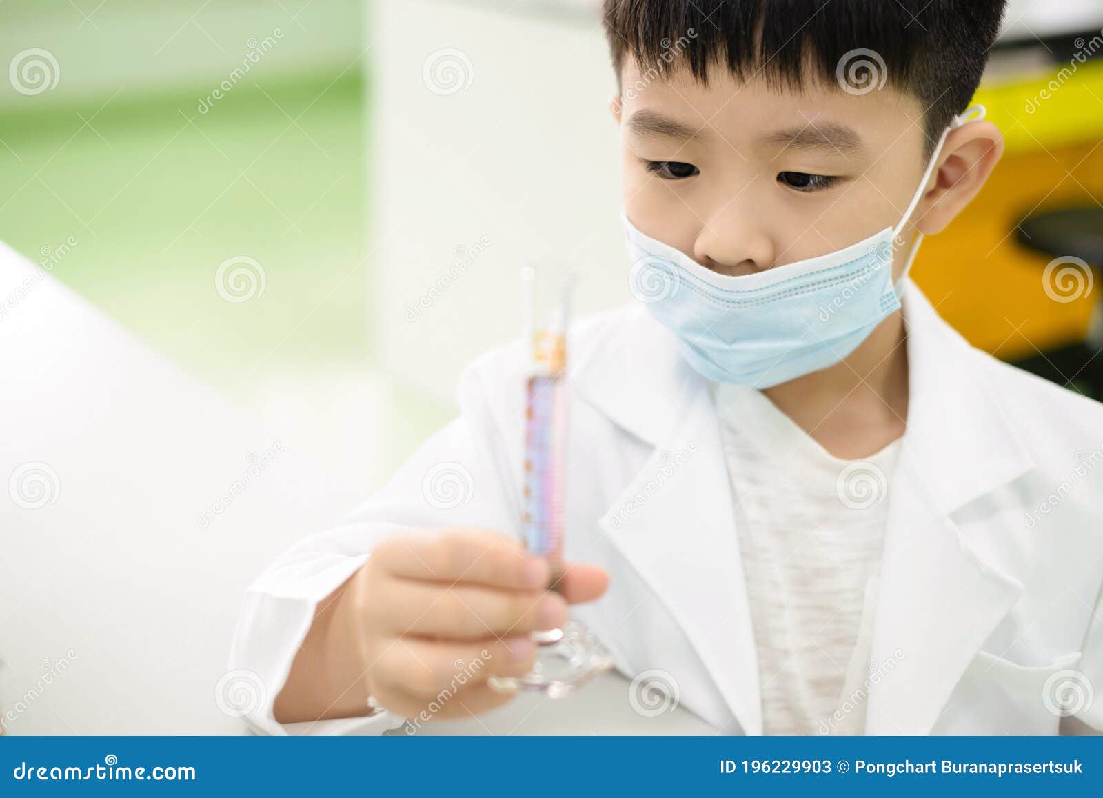 Elementary School Student Doing a Science Experiment. a Boy Looking at ...