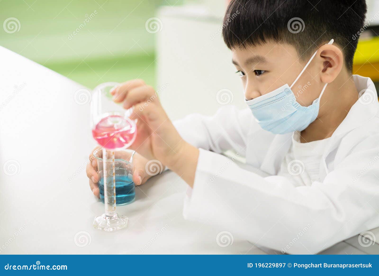 Elementary School Student Doing a Science Experiment. a Boy Pouring ...