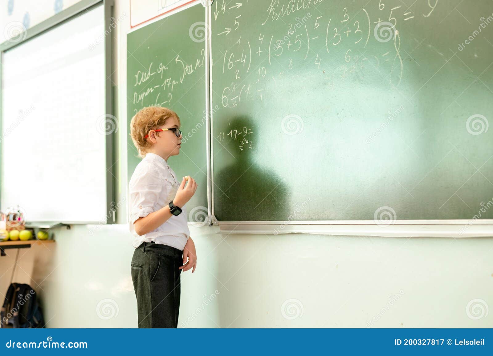 Elementary School Student Writing Maths Answer on Chalkboard Stock ...